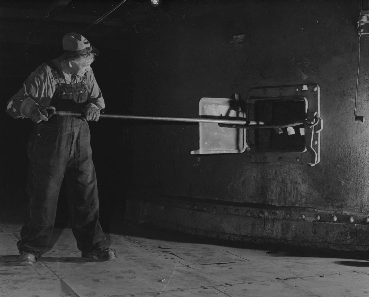 Man Cleaning Zinc Furnace at Anaconda Copper Mining Company, Great Falls